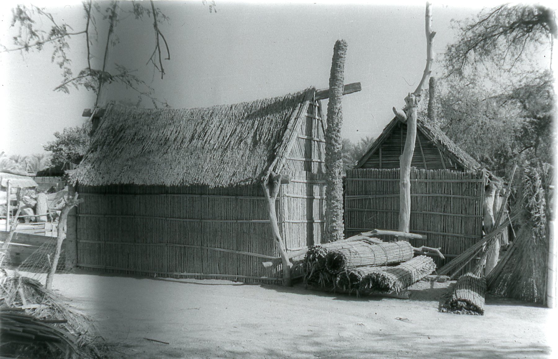 Red and grass thatched house | DW Digital Archive